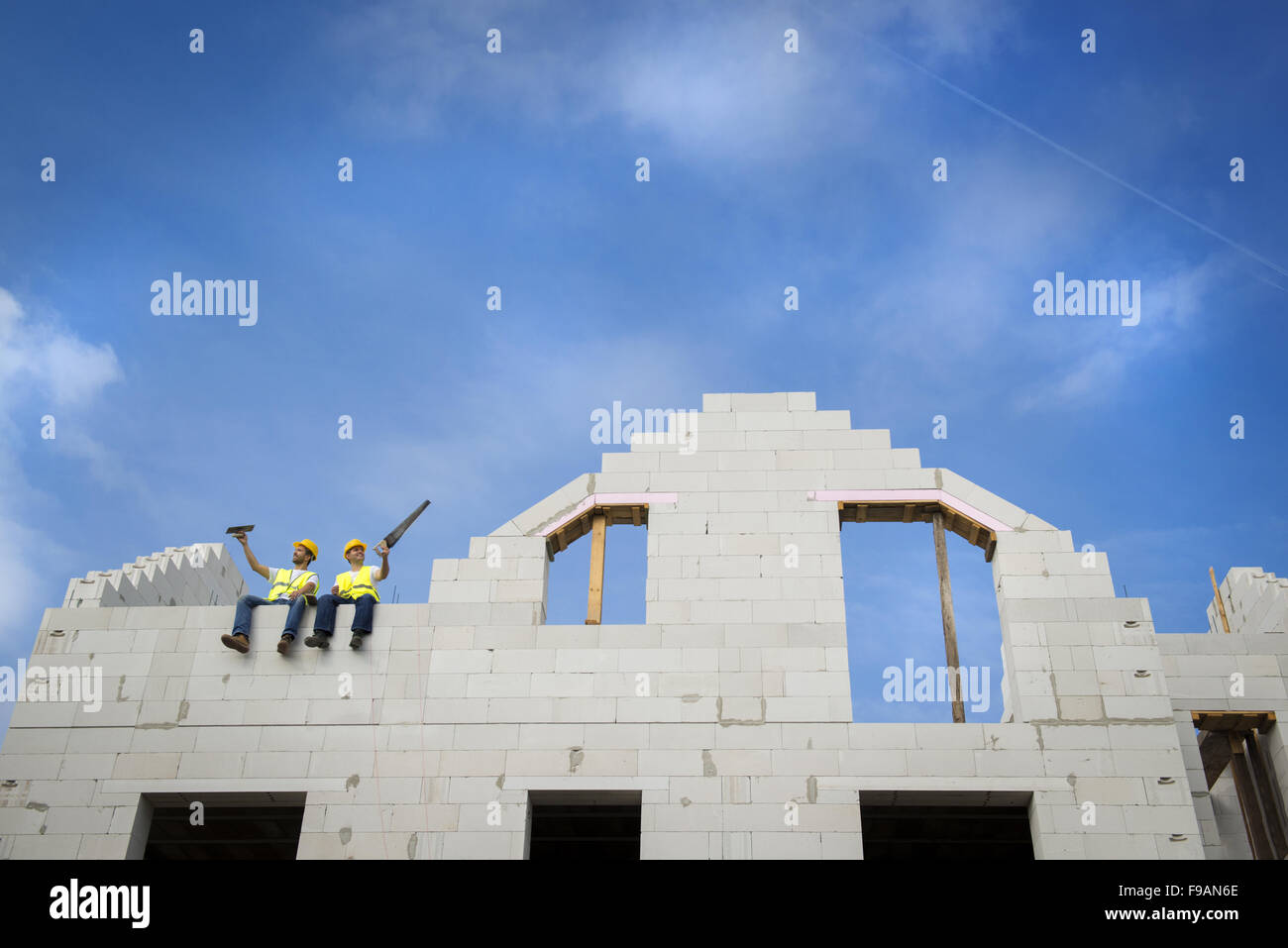 Construction Contractors building a big new home Stock Photo - Alamy