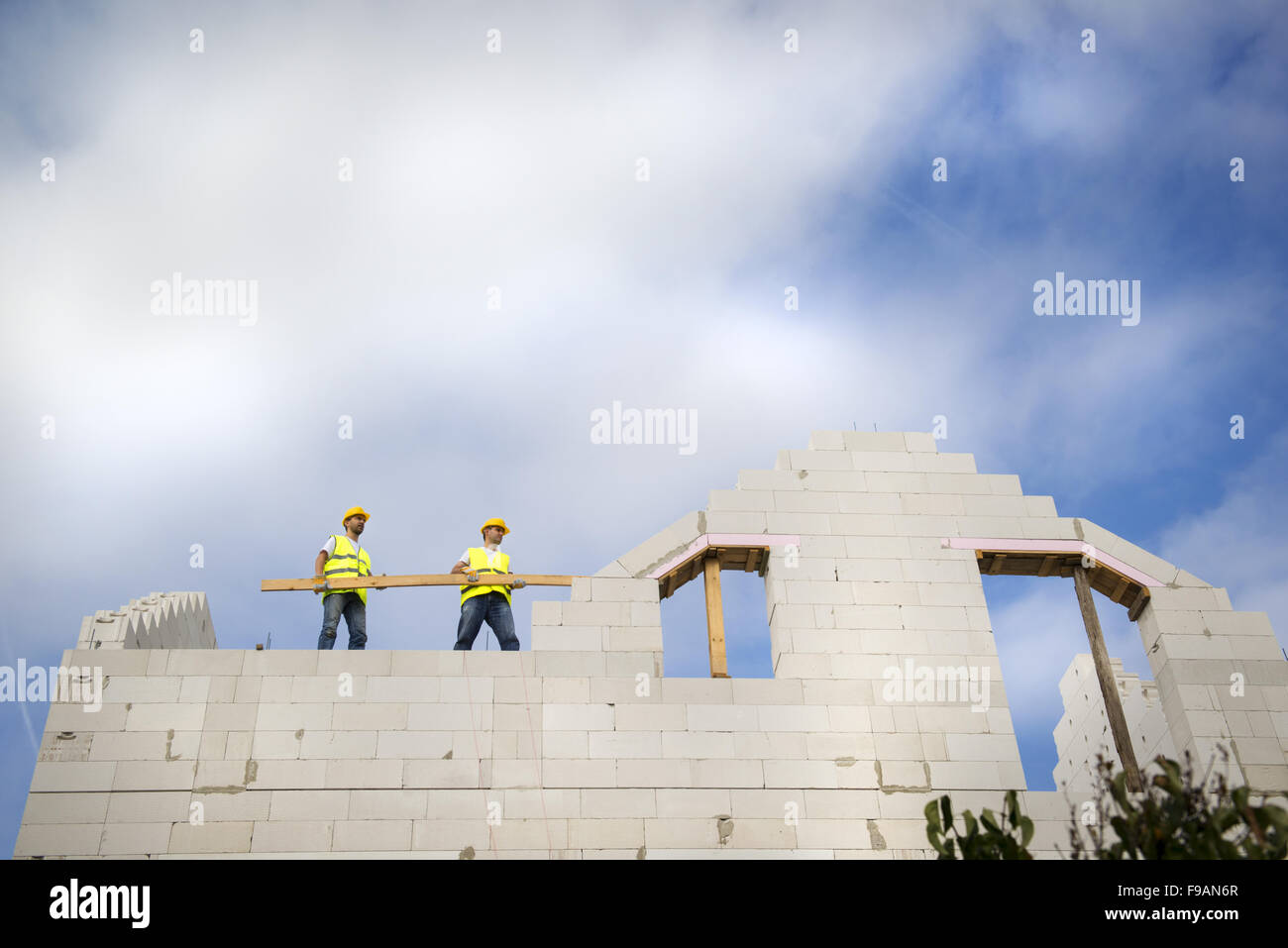 Construction Contractors building a big new home Stock Photo - Alamy