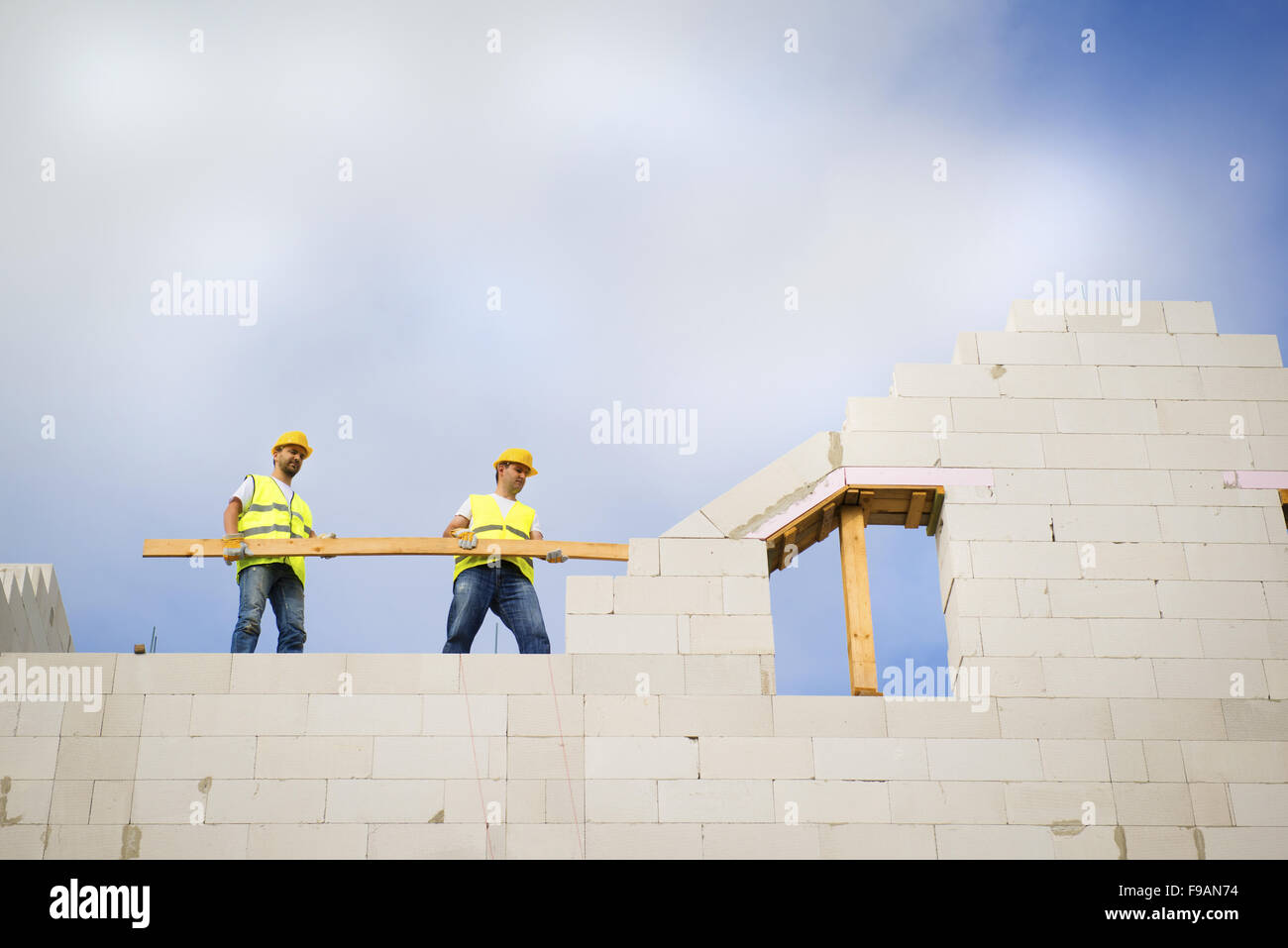 Construction Contractors building a big new home Stock Photo - Alamy