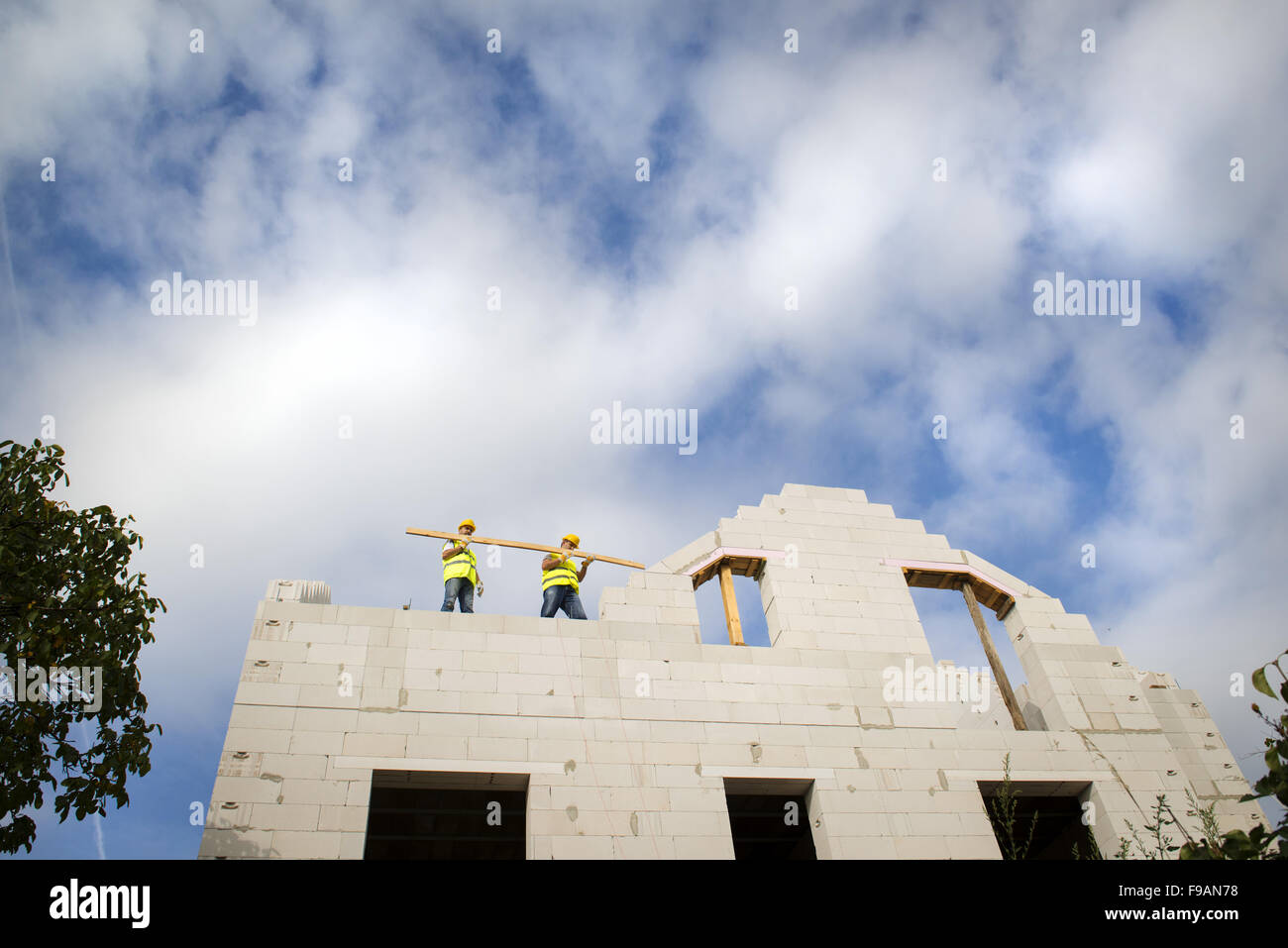 Construction Contractors building a big new home Stock Photo - Alamy
