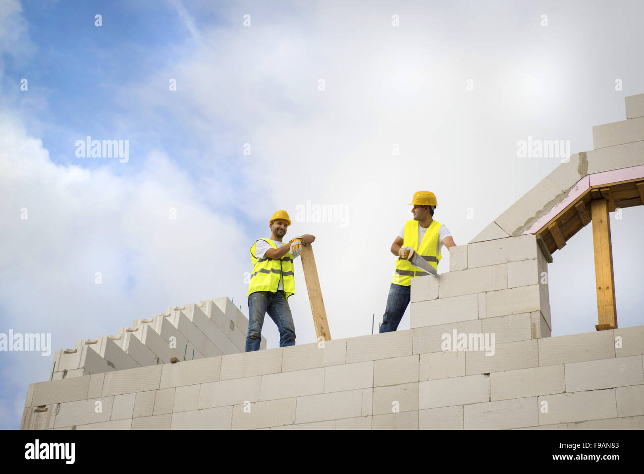 Construction Contractors building a big new home Stock Photo - Alamy