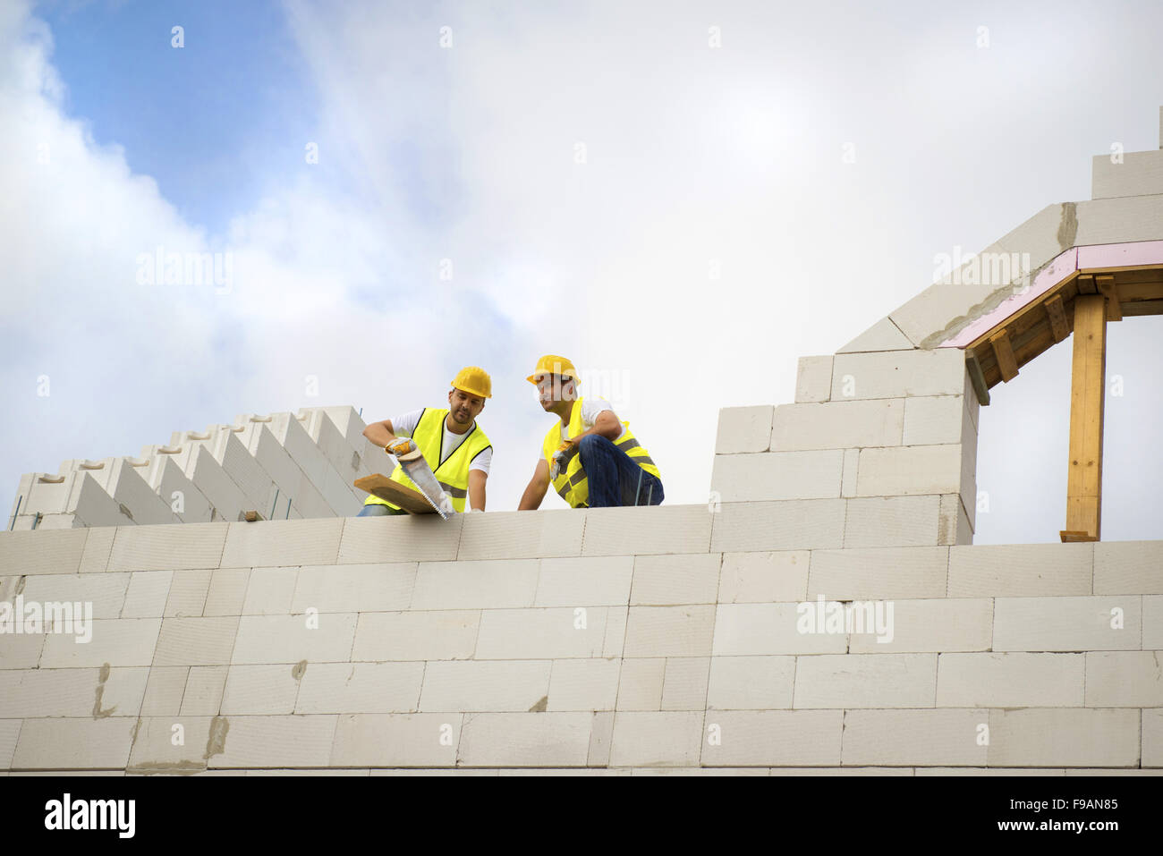 Construction Contractors building a big new home Stock Photo - Alamy