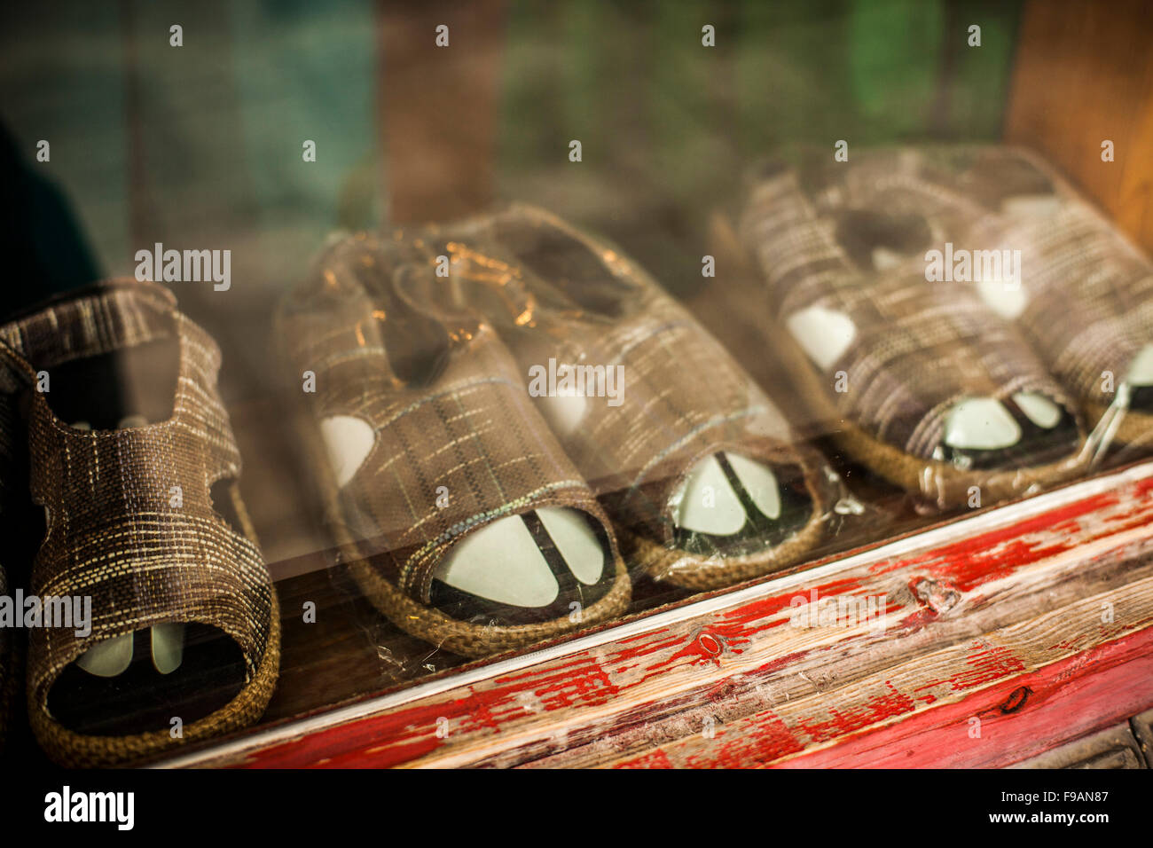 Sandals on display in a shop window Stock Photo - Alamy