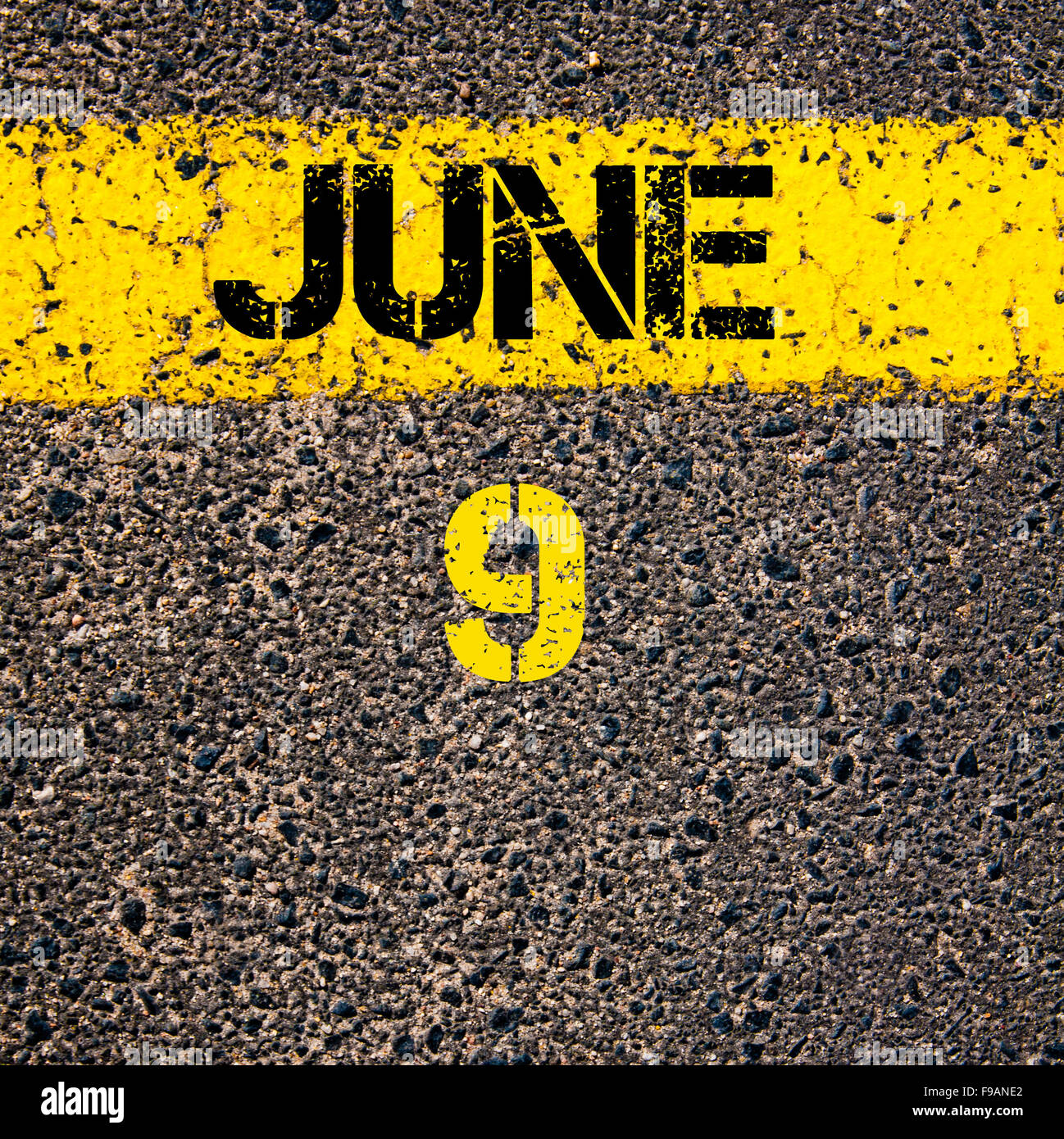 9 June calendar day written over road marking yellow paint line Stock ...