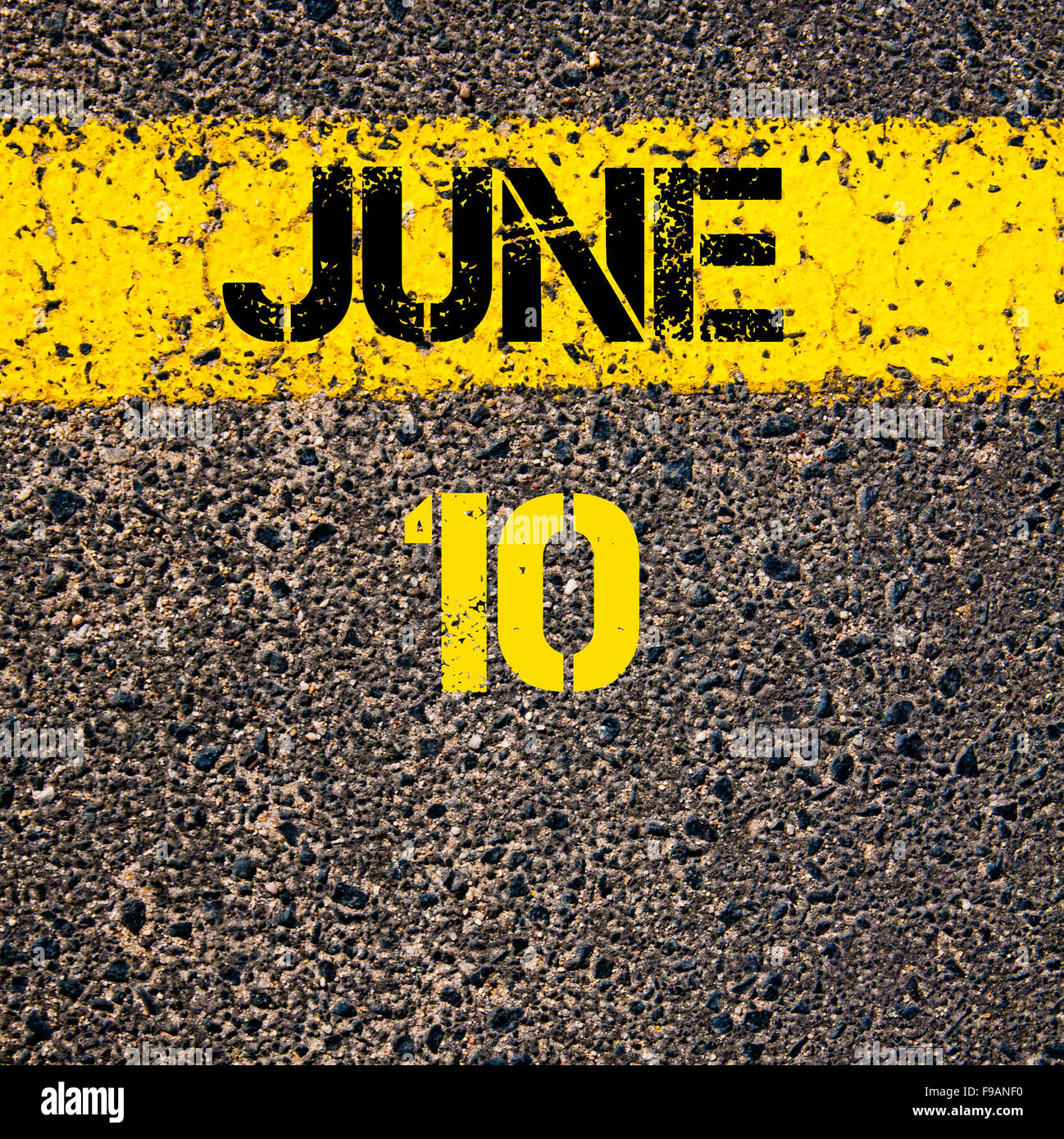 10 June calendar day written over road marking yellow paint line Stock ...