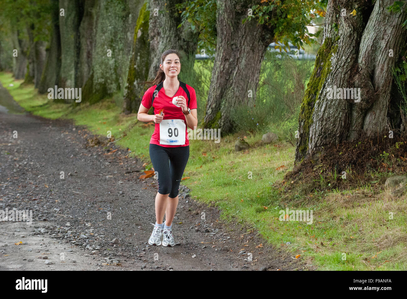 Woman running in half marathon at Crathes Castle in Aberdeenshire ...