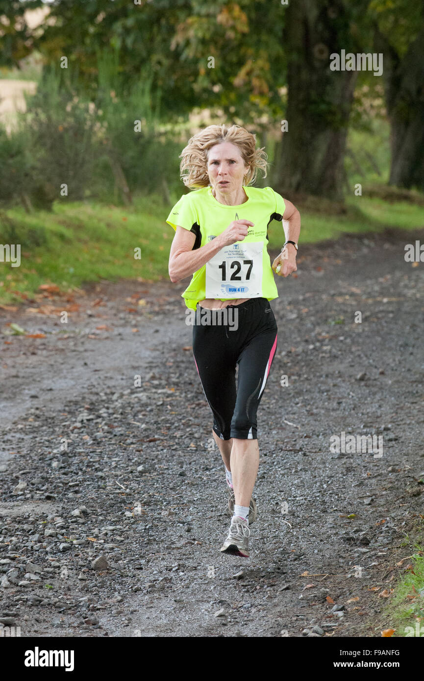 Woman running in half marathon at Crathes Castle in Aberdeenshire ...