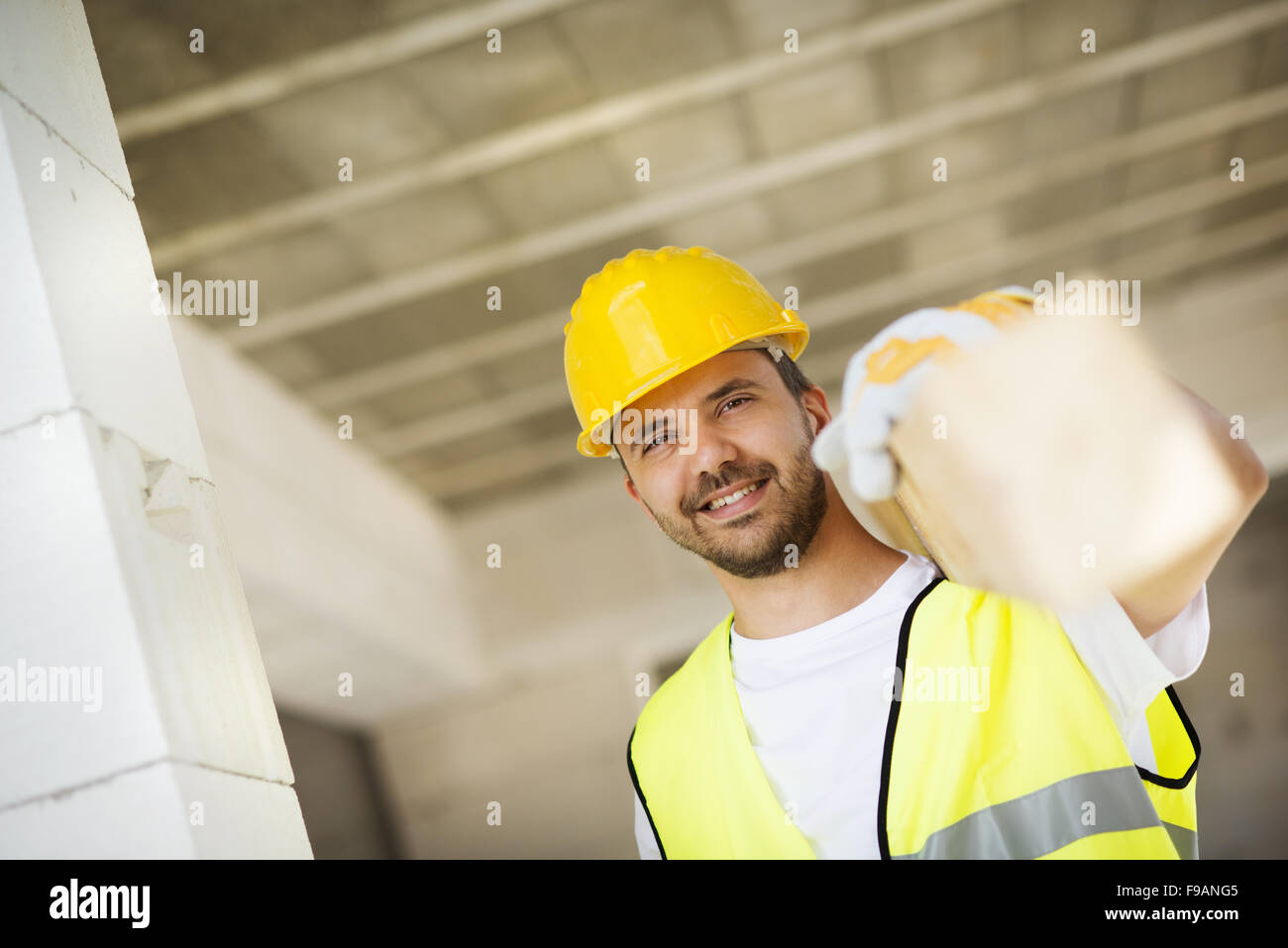 Construction worker is working on new house Stock Photo - Alamy
