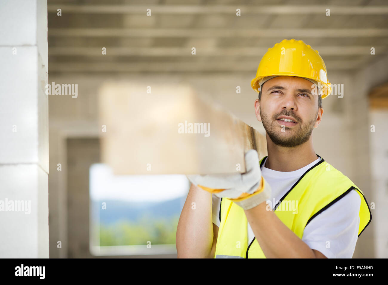 Construction worker is working on new house Stock Photo - Alamy