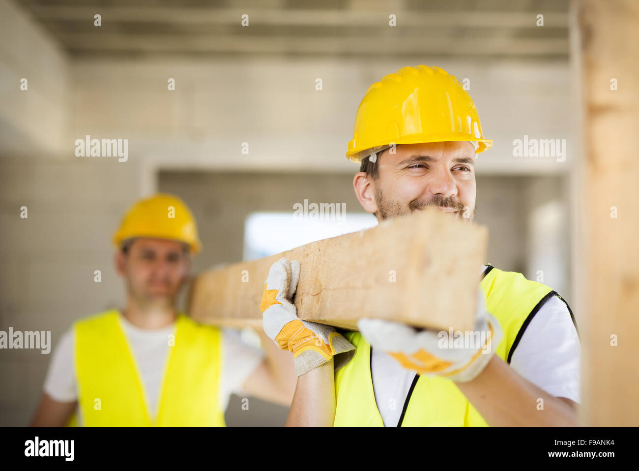 Construction workers collaborating on new house building Stock Photo ...