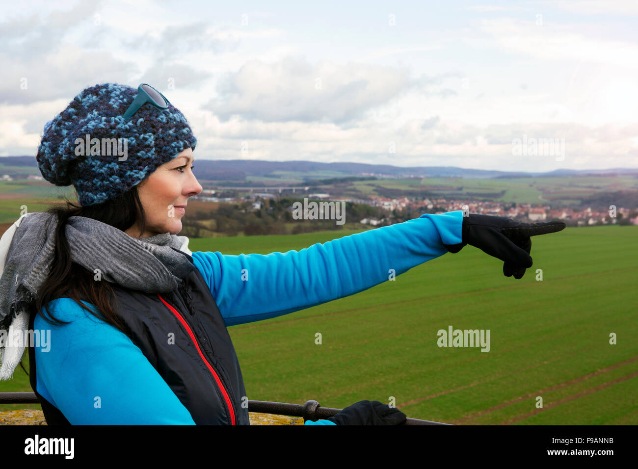woman in fall standing outside and pointing at something Stock Photo ...
