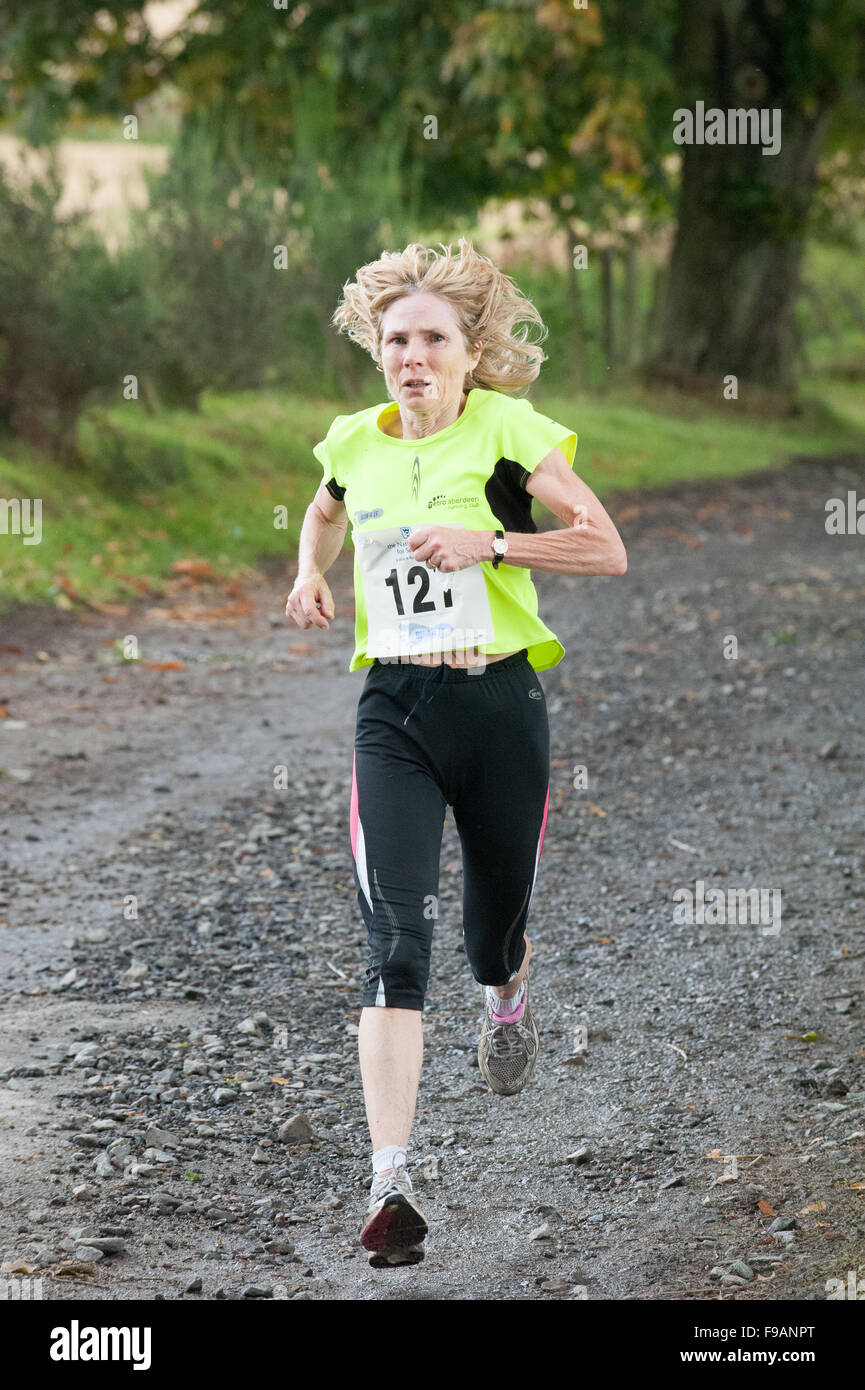 Woman running in half marathon at Crathes Castle in Aberdeenshire ...