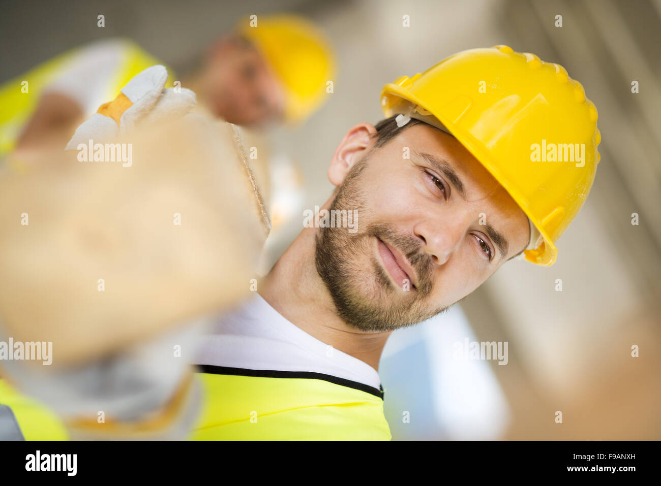 Construction workers collaborating on new house building Stock Photo ...