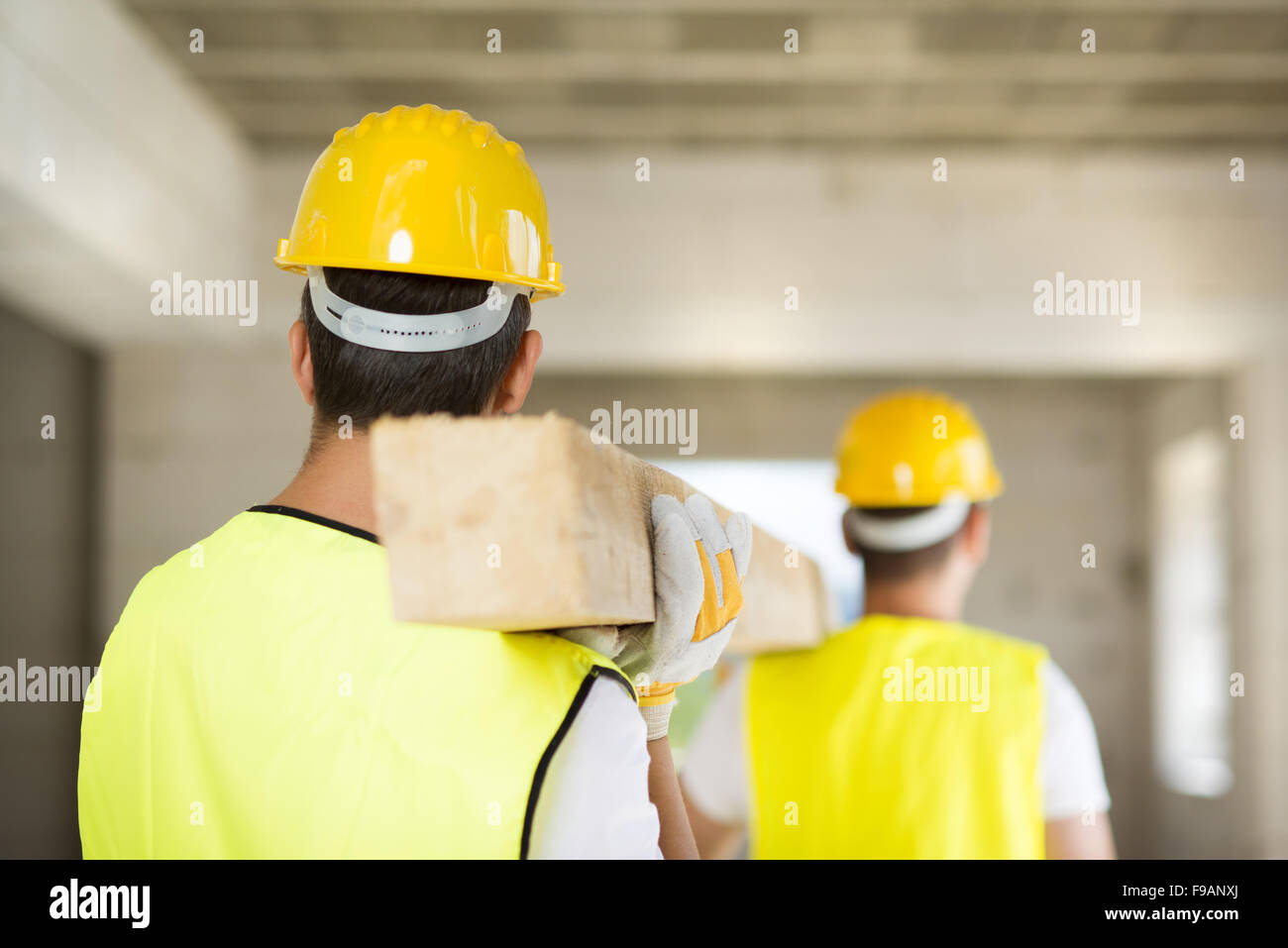 Construction workers collaborating on new house building Stock Photo ...