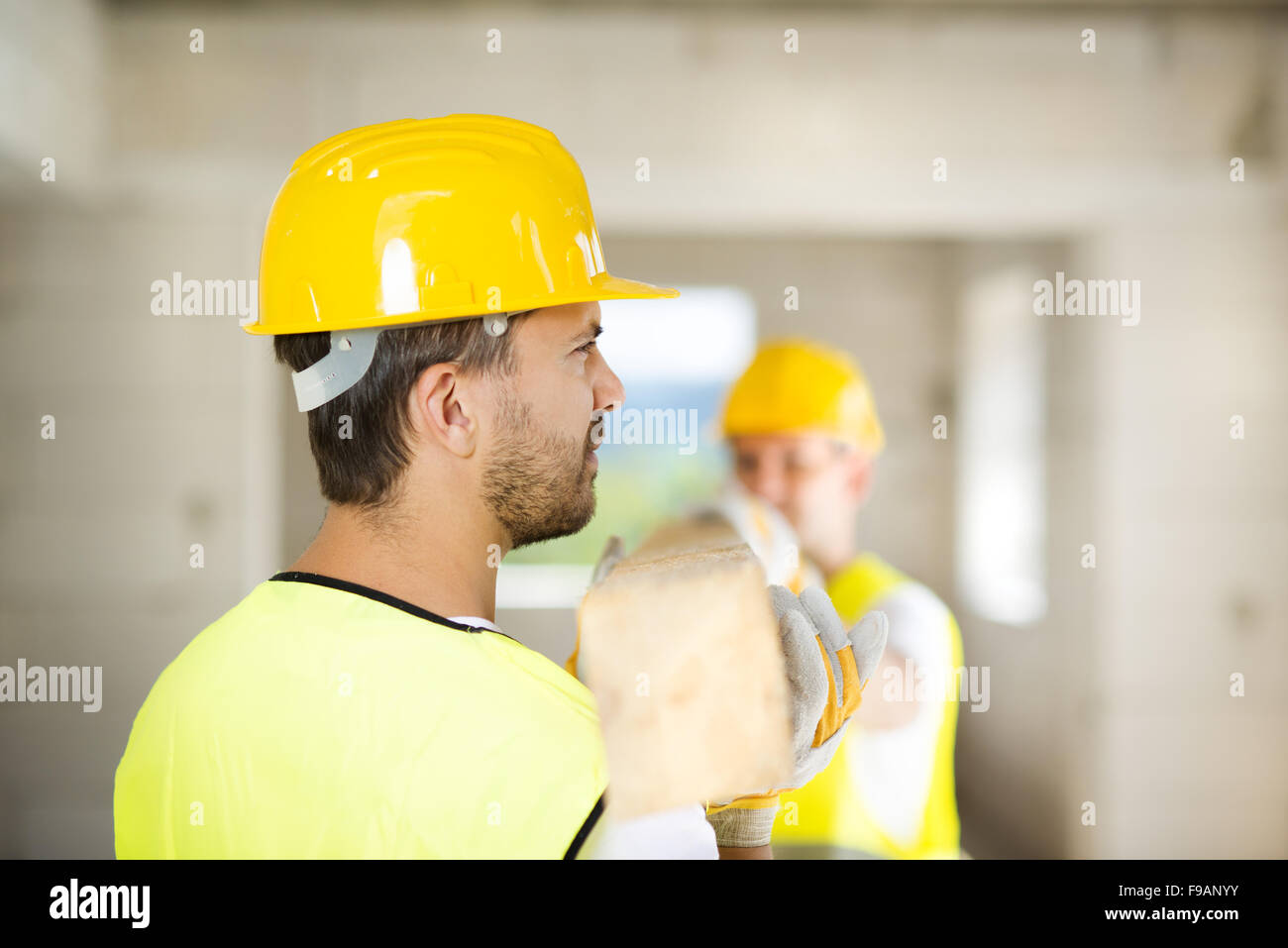 Construction workers collaborating on new house building Stock Photo ...
