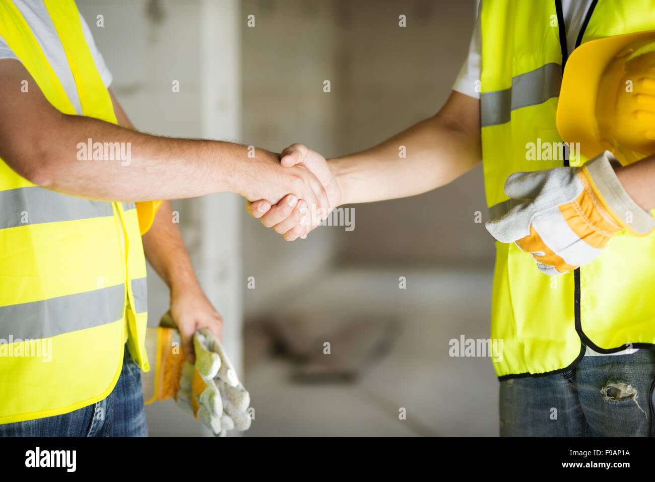 Construction workers collaborating on new house building Stock Photo ...
