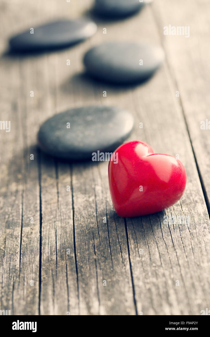 Heart stone on black rock hi-res stock photography and images - Alamy