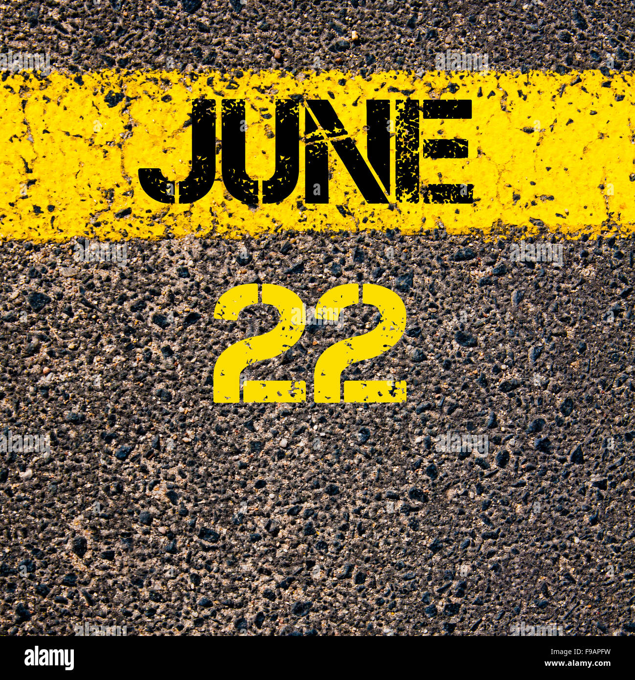 22 June calendar day written over road marking yellow paint line Stock ...