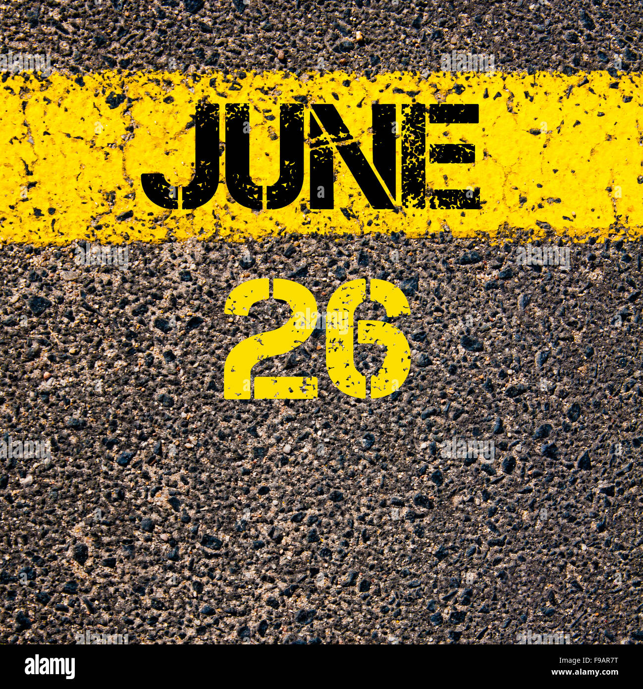 26 June calendar day written over road marking yellow paint line Stock ...
