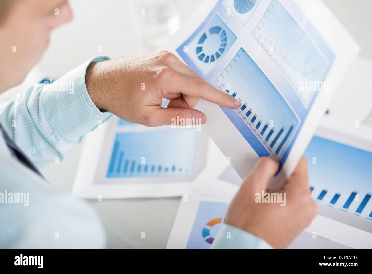 Business people reading graphs and charts Stock Photo - Alamy