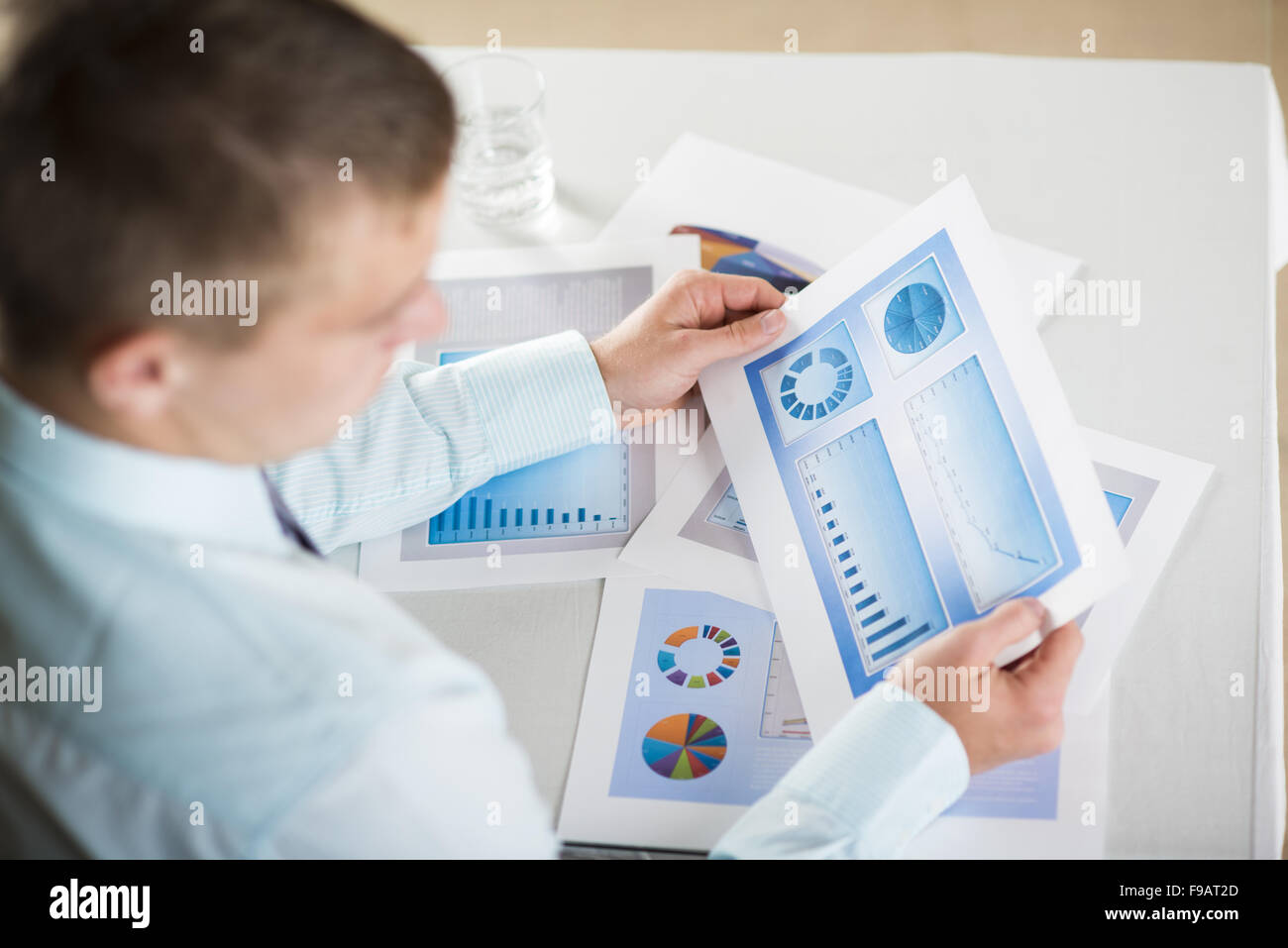 Business people reading graphs and charts Stock Photo - Alamy