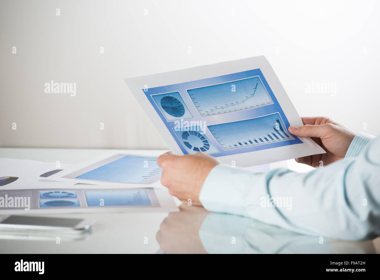 Business people reading graphs and charts Stock Photo - Alamy