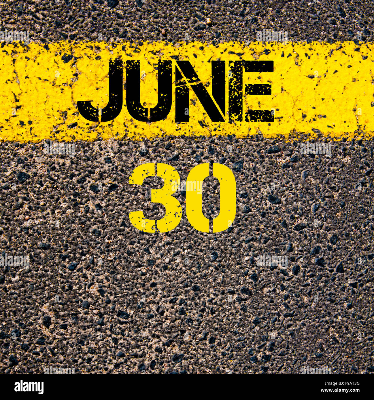 30 June calendar day written over road marking yellow paint line Stock ...