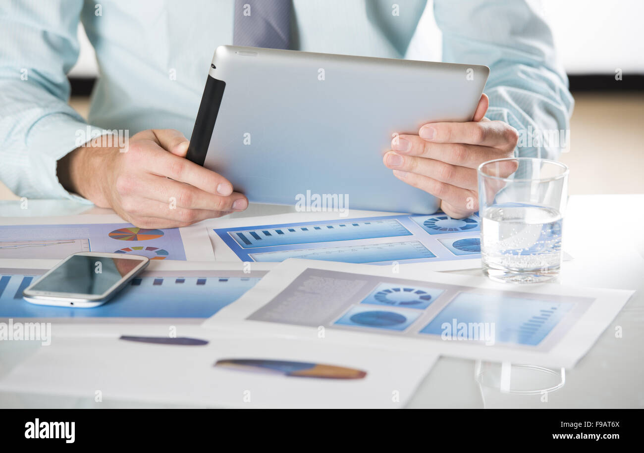 Business people reading graphs and charts Stock Photo - Alamy
