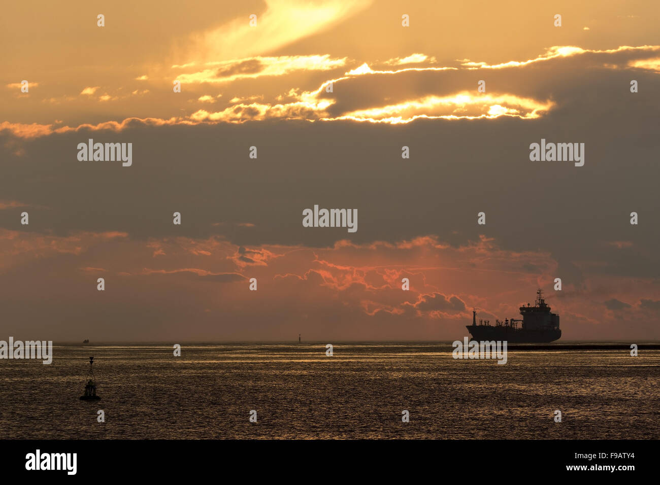 Ships on the sea in the rain, during sunrise Stock Photo - Alamy