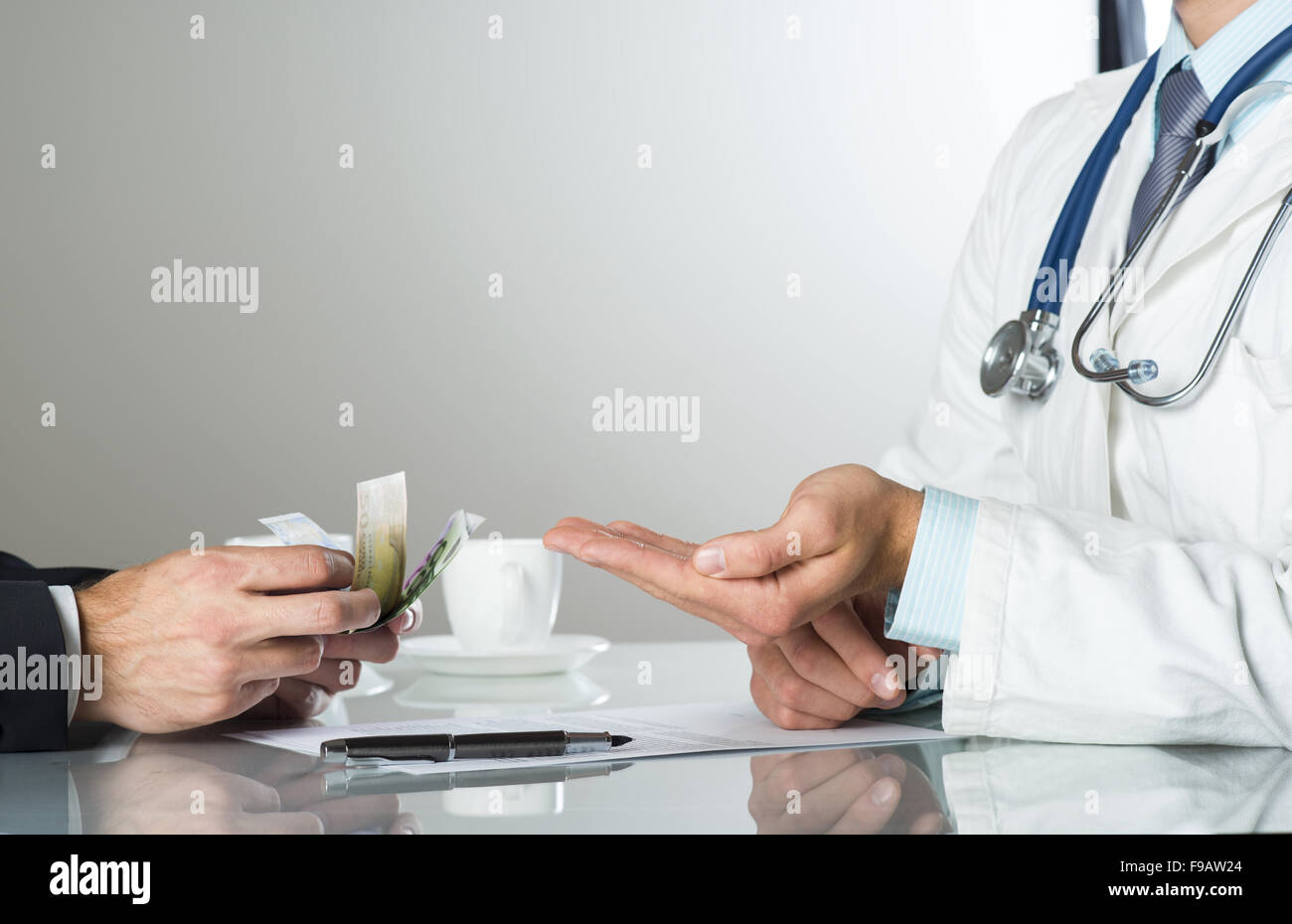 Closeup on medical doctor hands, taking money Stock Photo - Alamy