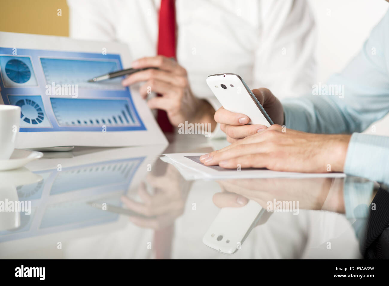 Business people reading graphs and charts Stock Photo - Alamy