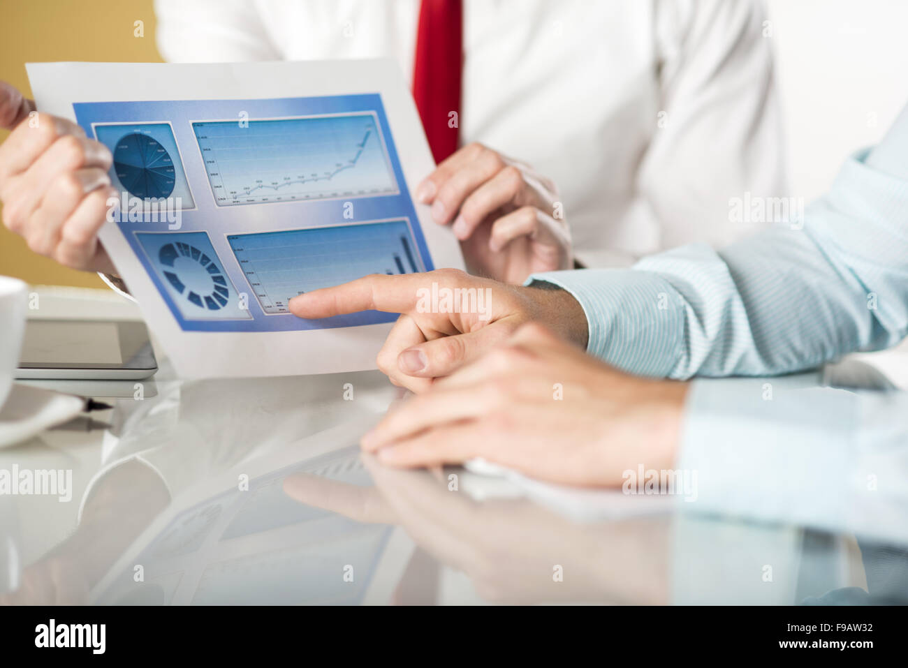 Business people reading graphs and charts Stock Photo - Alamy