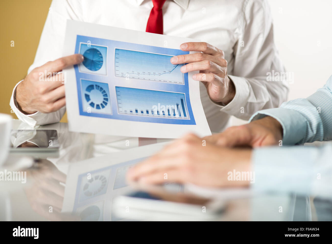 Business people reading graphs and charts Stock Photo - Alamy
