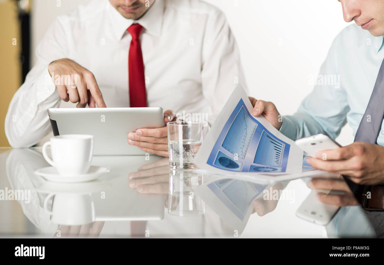 Business people reading graphs and charts Stock Photo - Alamy