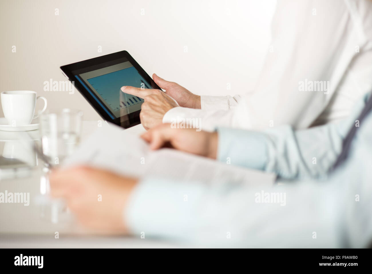 Business people reading graphs and charts Stock Photo - Alamy