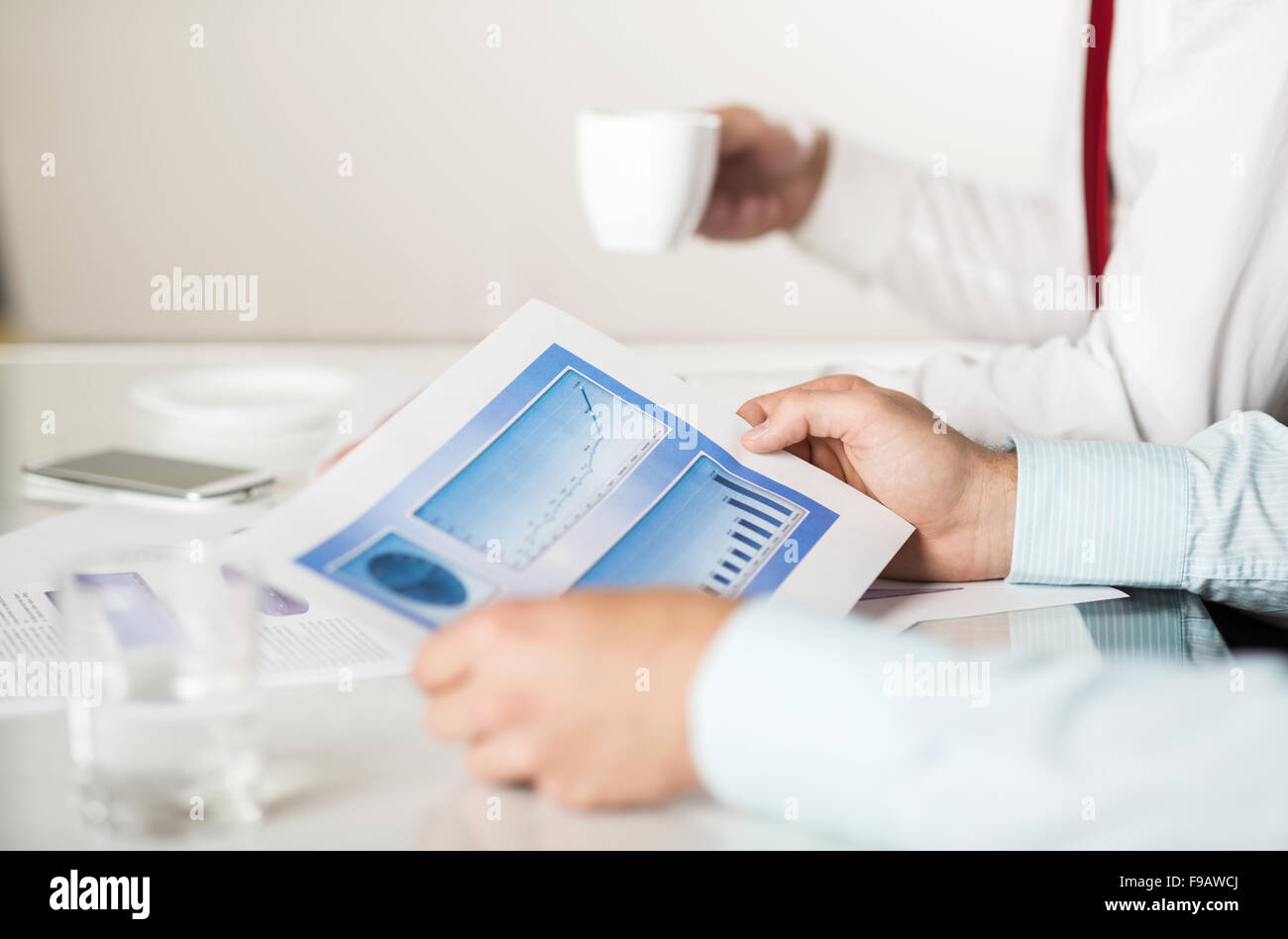 Business people reading graphs and charts Stock Photo - Alamy