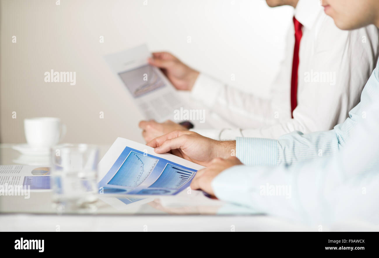 Business people reading graphs and charts Stock Photo - Alamy