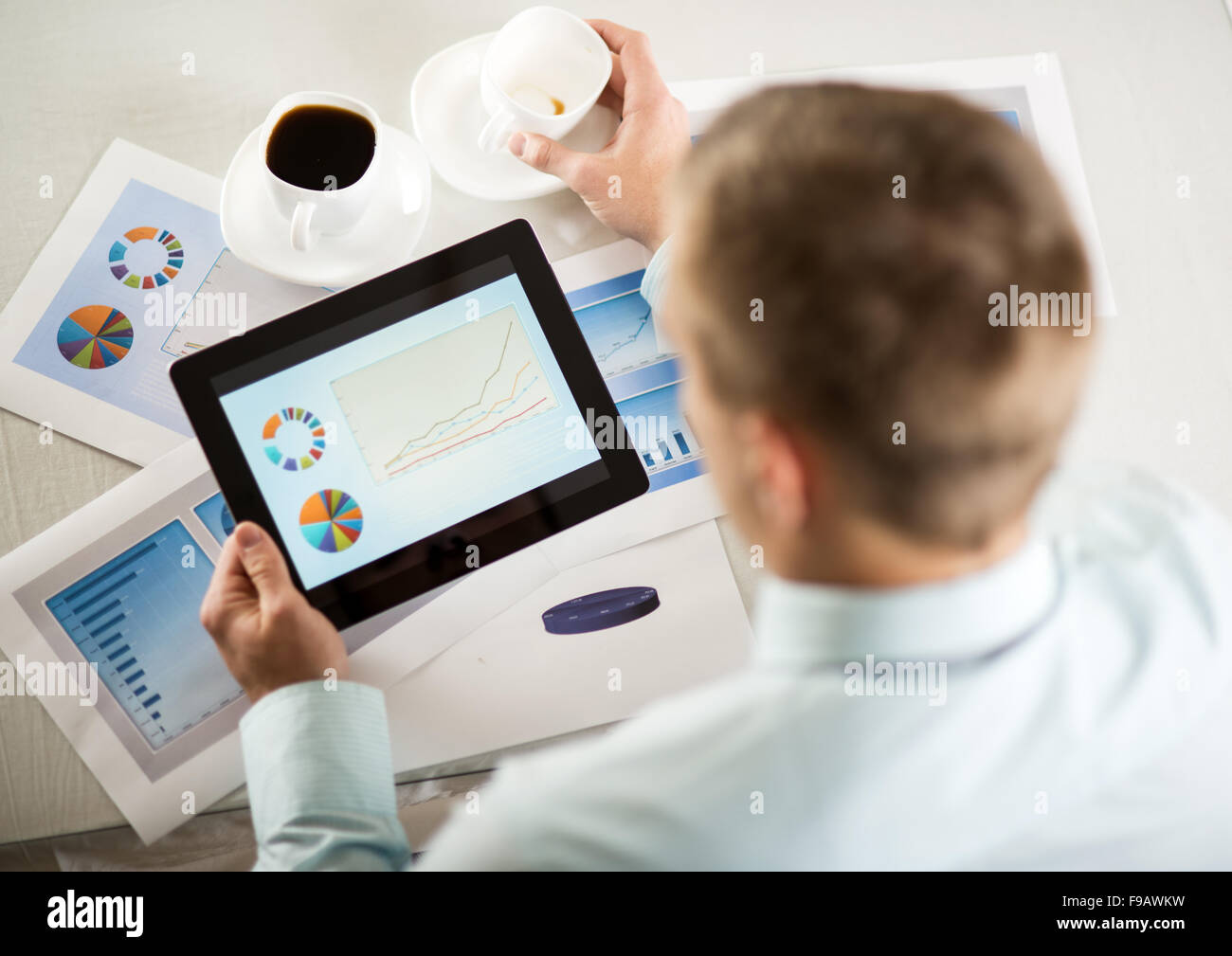 Business people reading graphs and charts Stock Photo - Alamy