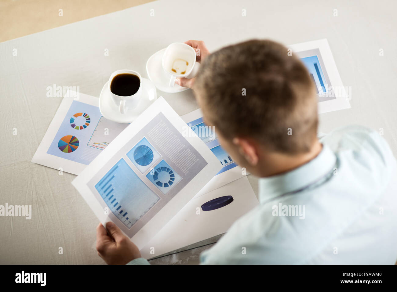 Business people reading graphs and charts Stock Photo - Alamy