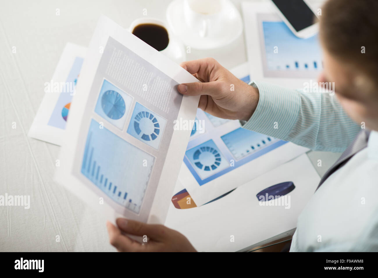 Business people reading graphs and charts Stock Photo - Alamy