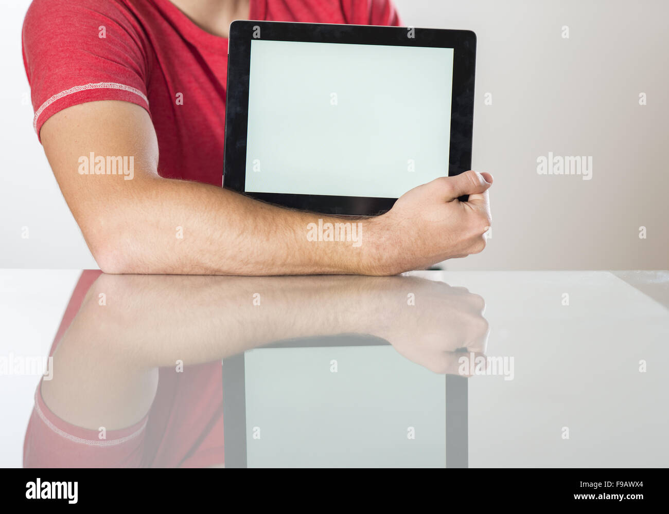 Detail of hands with tablet computer in studio Stock Photo - Alamy