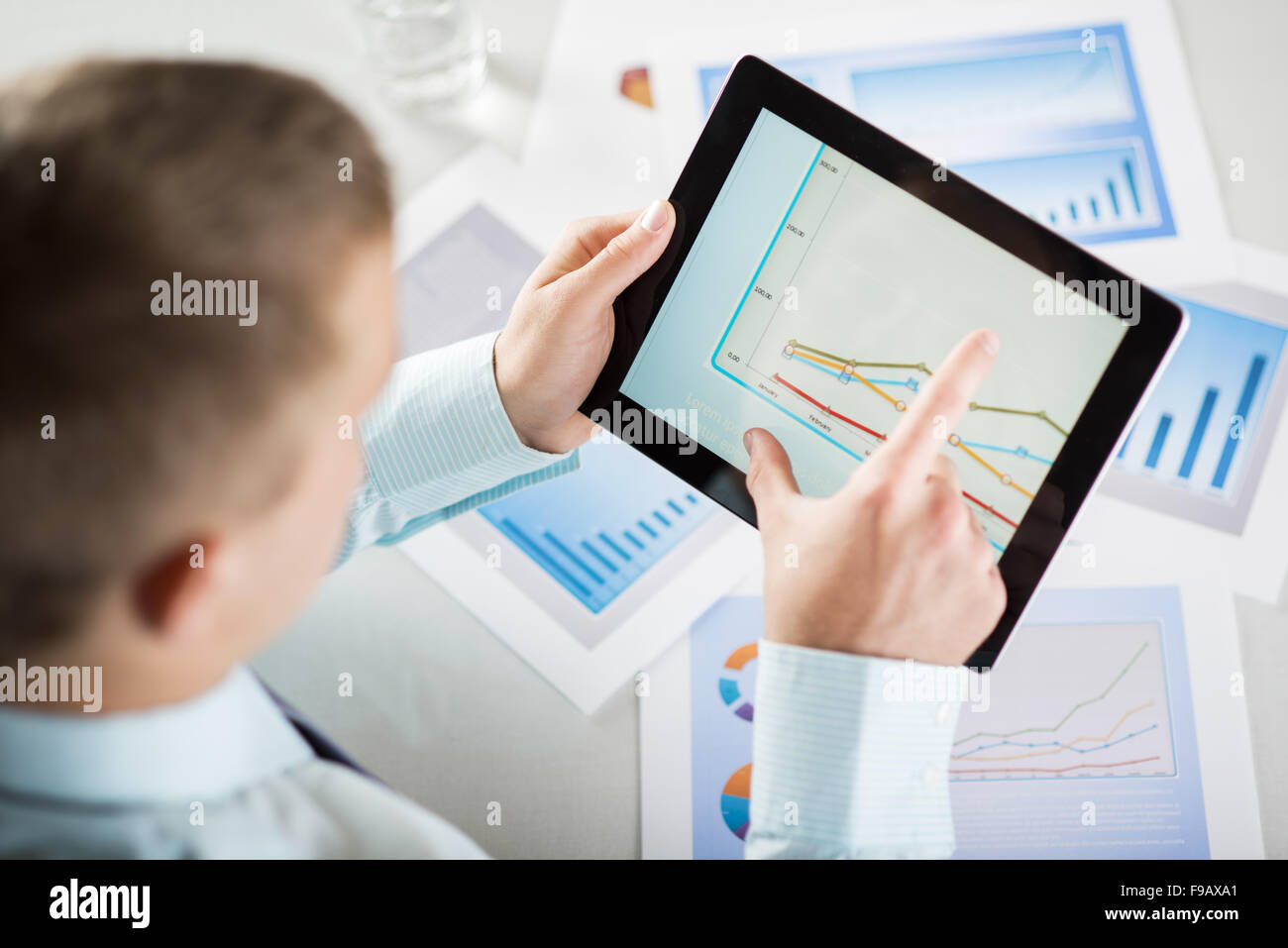 Businessman is reading business graphs and charts Stock Photo - Alamy