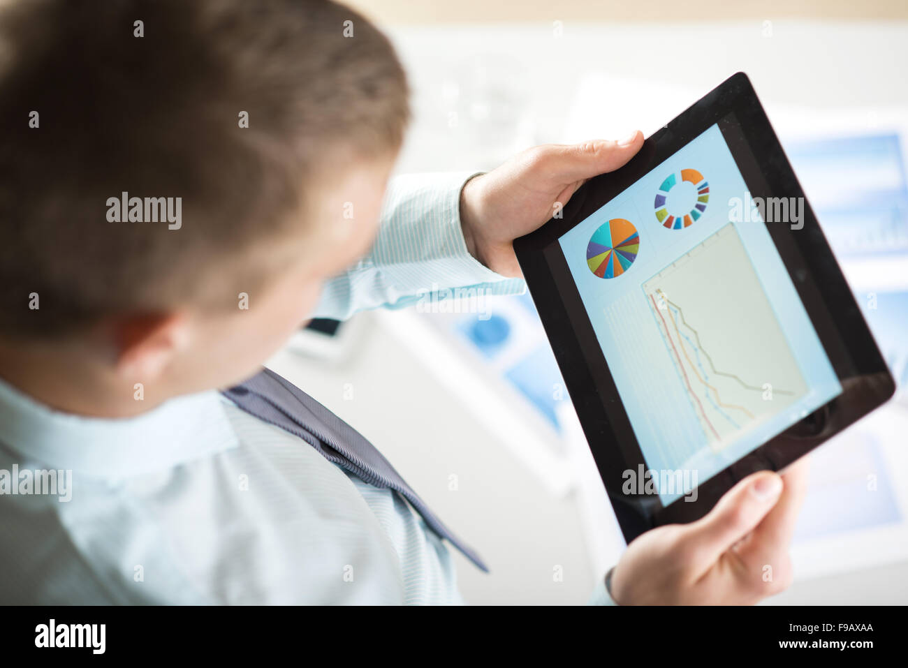 Businessman is reading business graphs and charts Stock Photo - Alamy