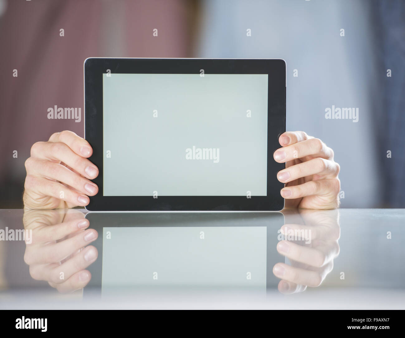 Detail of hands with tablet computer in studio Stock Photo - Alamy