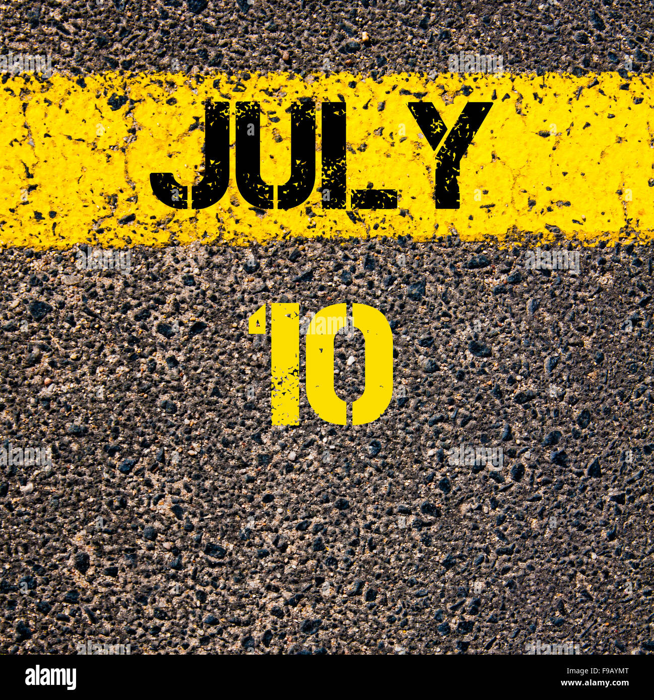 10 July calendar day written over road marking yellow paint line Stock ...