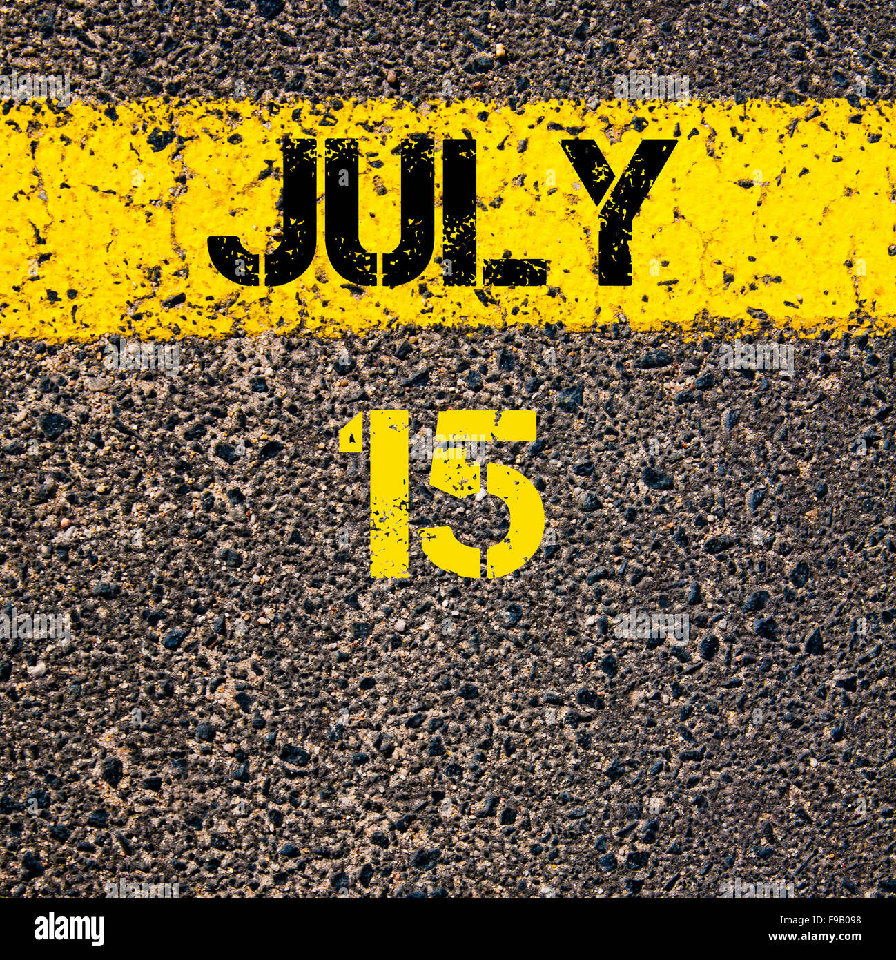 15 July calendar day written over road marking yellow paint line Stock ...