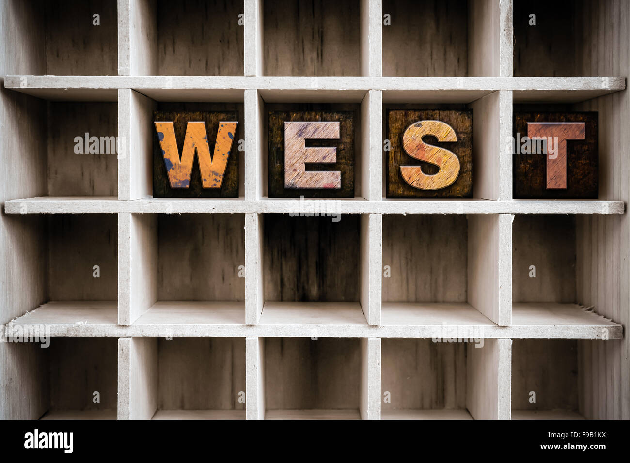 The word "WEST" written in vintage ink stained wooden letterpress type ...