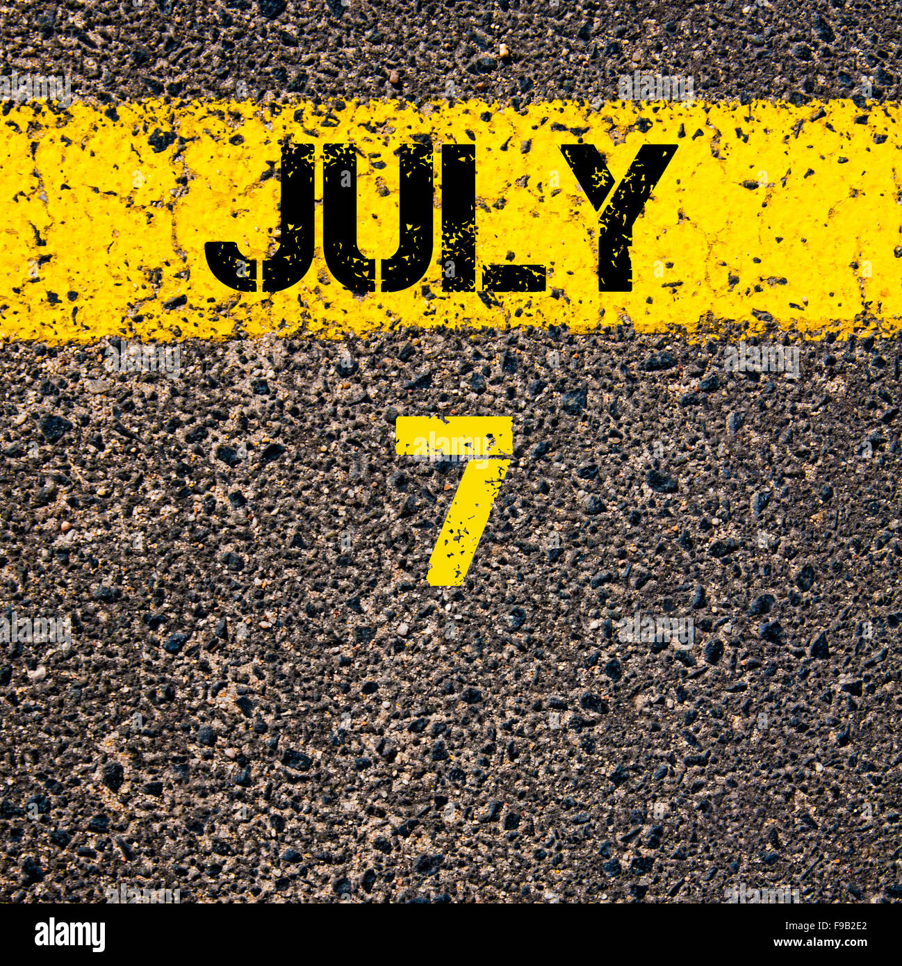 7 July calendar day written over road marking yellow paint line Stock ...