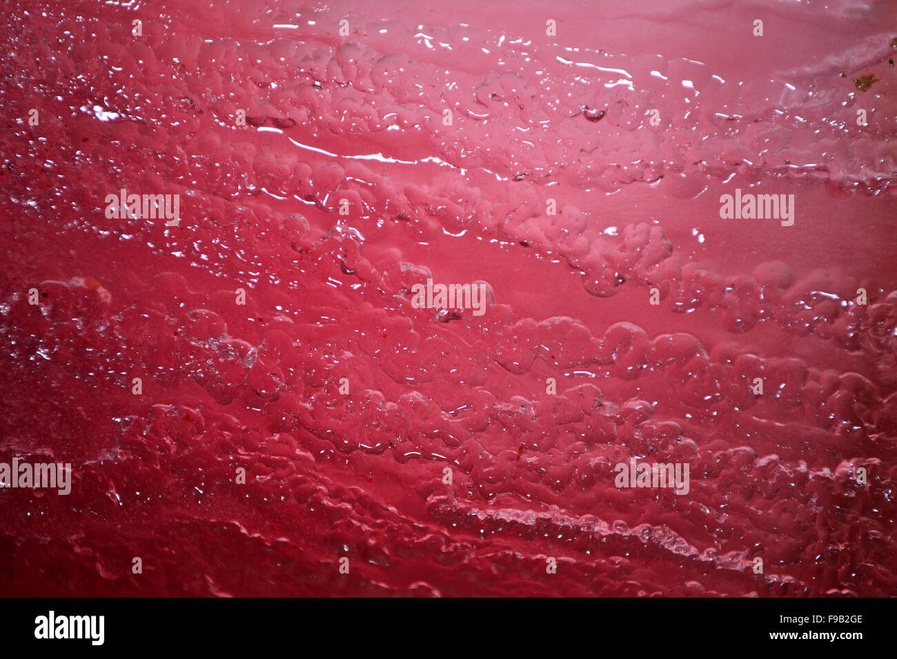 Red pink frozen water ice icy structure abstract Stock Photo - Alamy