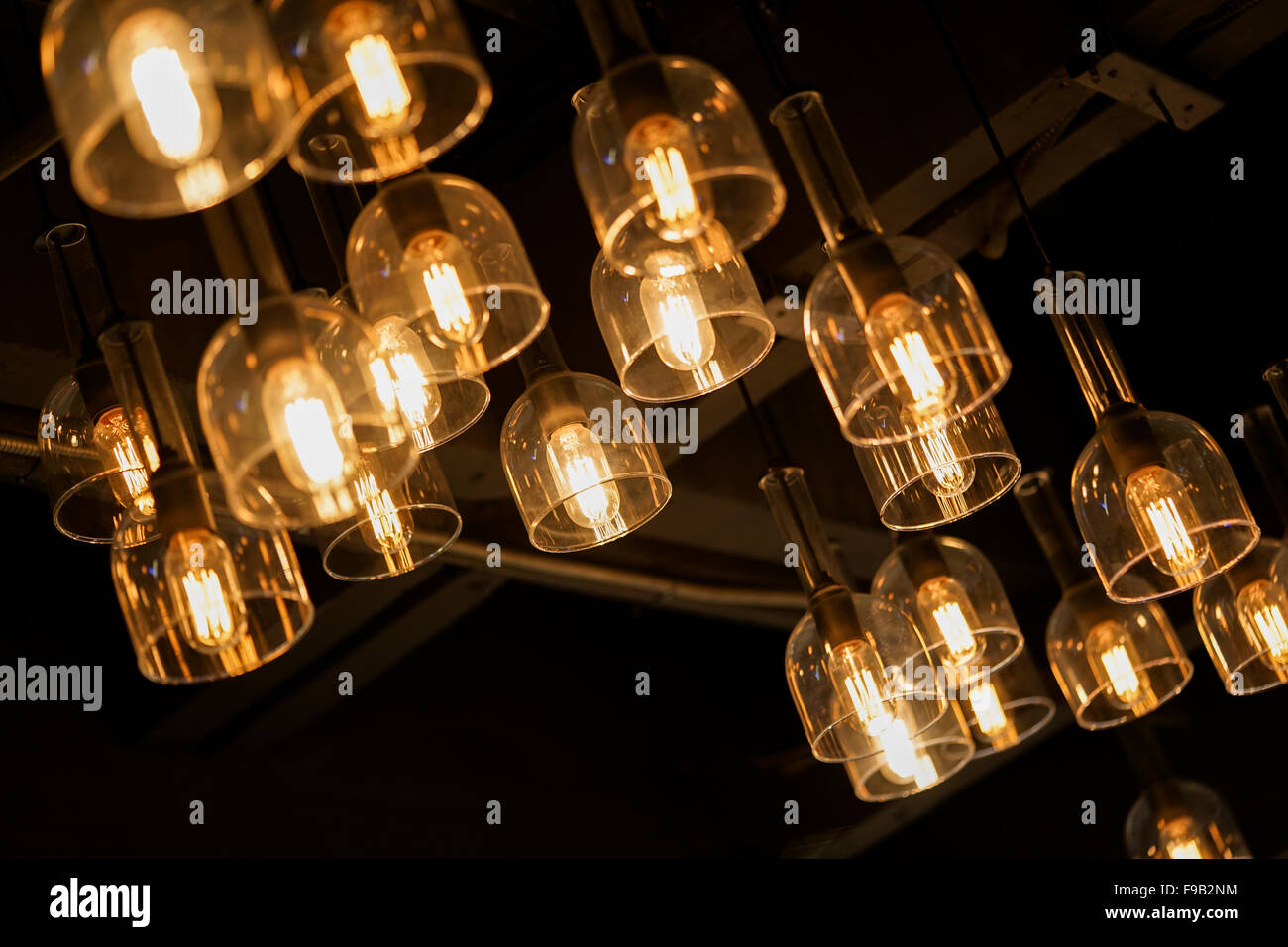 Vintage hanging light bulbs on dark background Stock Photo - Alamy